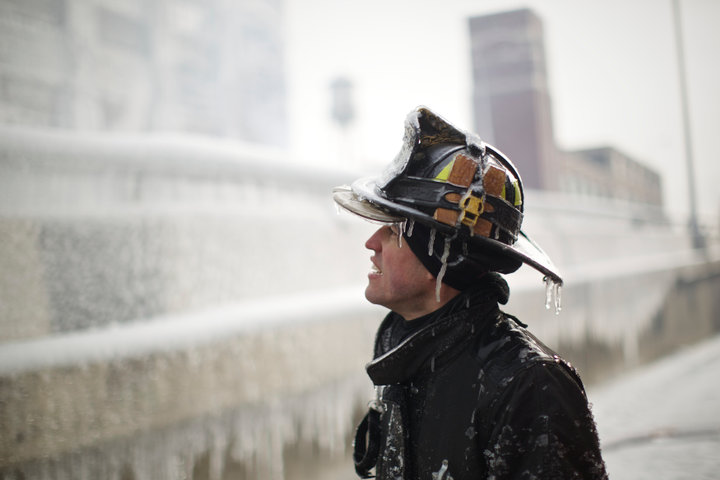 Chicago Firefighter Michael De Jesus is covered in ice as he mans a ...