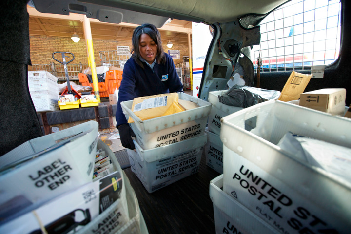 United States Postal Service clerks sort mail at the USPS Lincoln Park ...